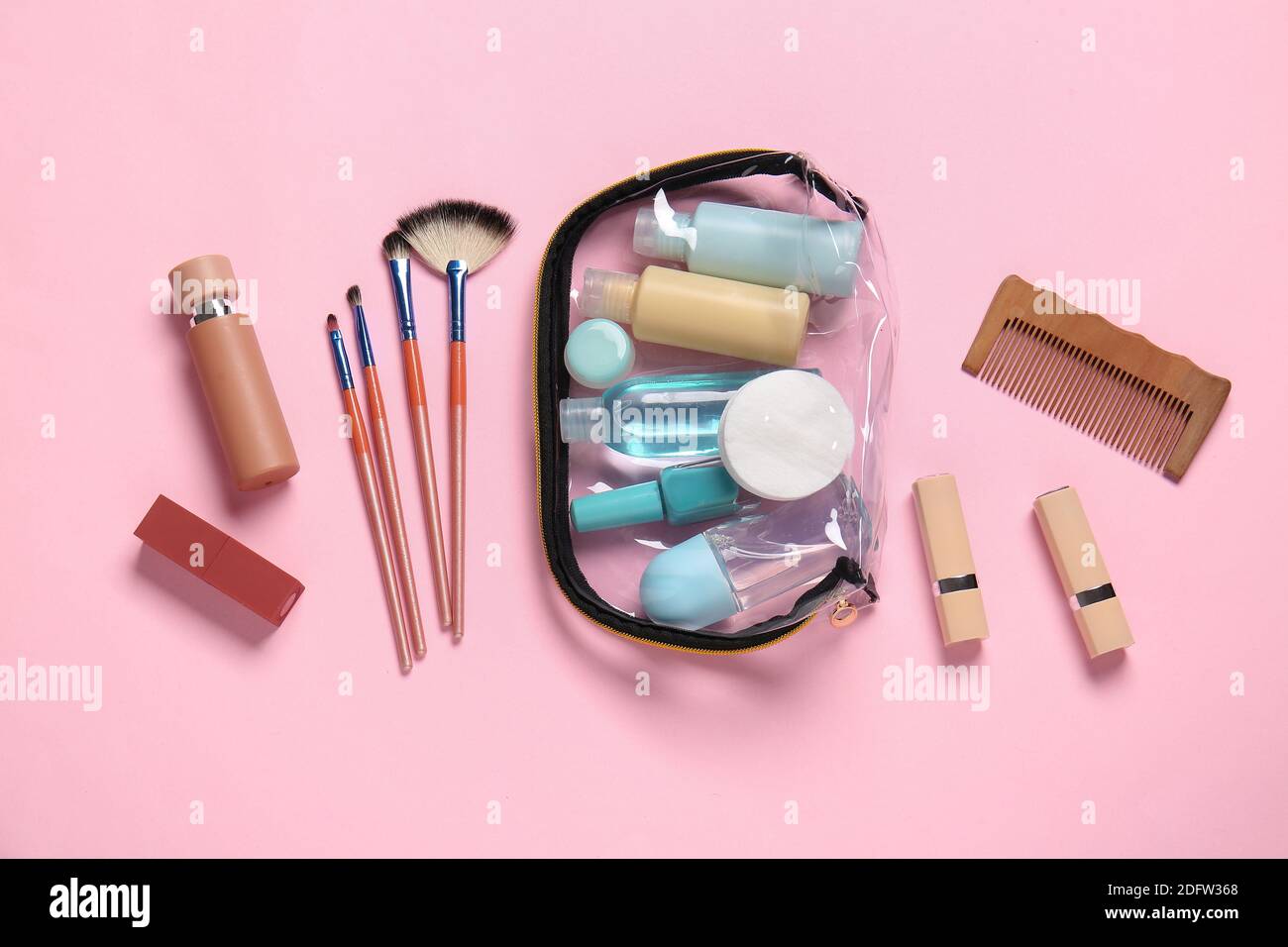Travel cosmetics kit on color background Stock Photo - Alamy