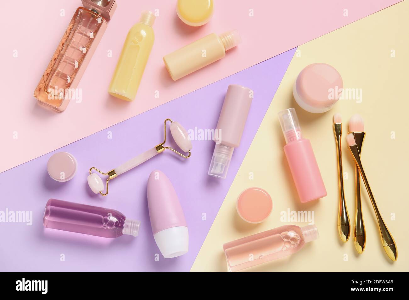 Travel cosmetics kit on color background Stock Photo - Alamy