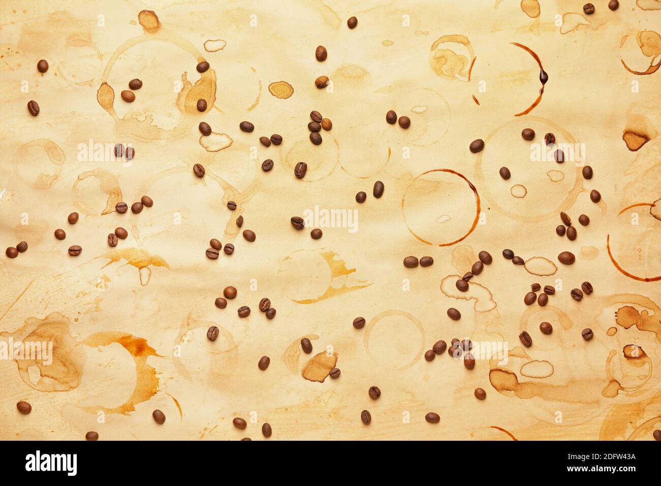 Brown coffee stains and beans on light background Stock Photo - Alamy
