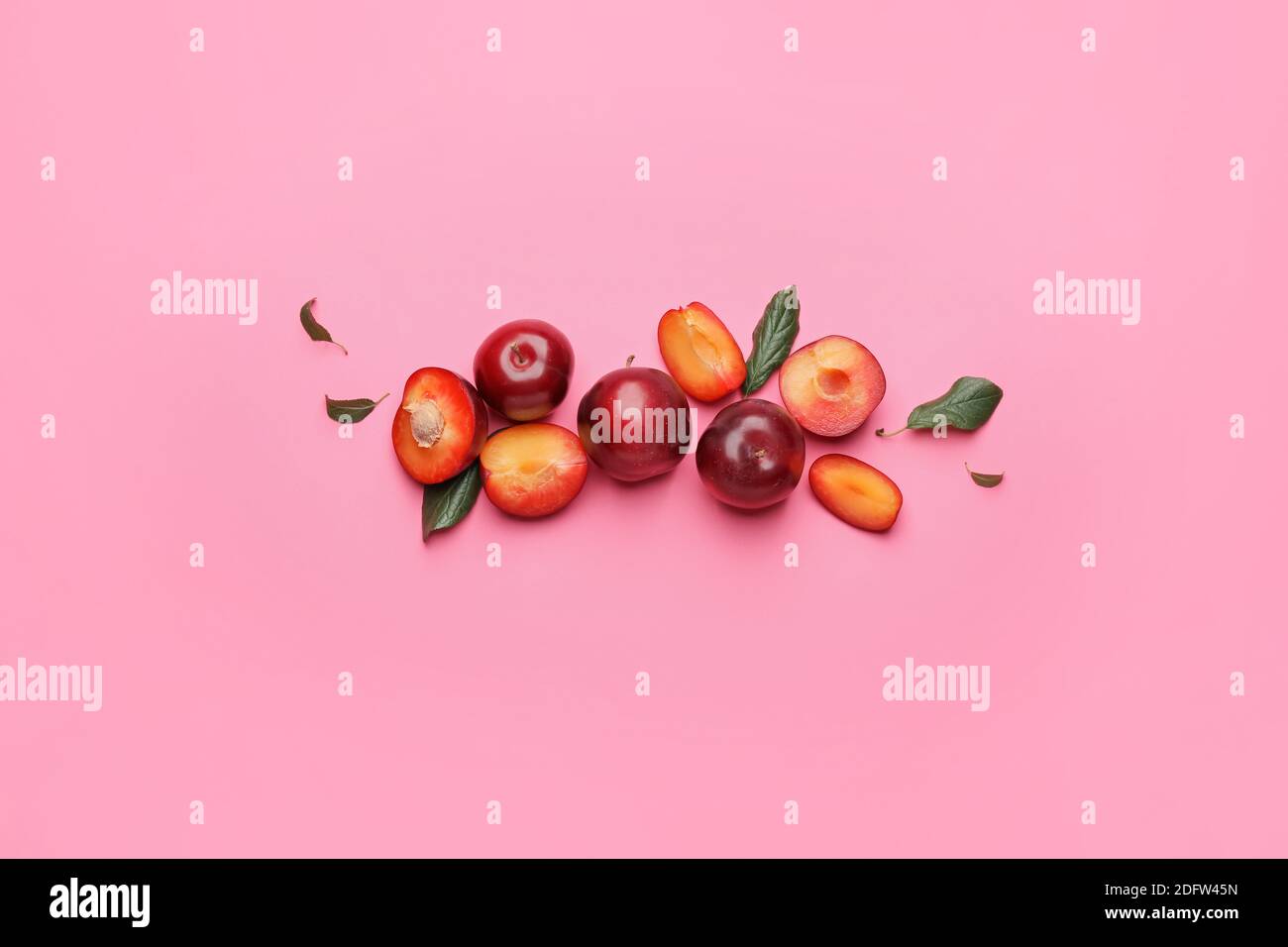Fresh ripe plums on color background Stock Photo - Alamy