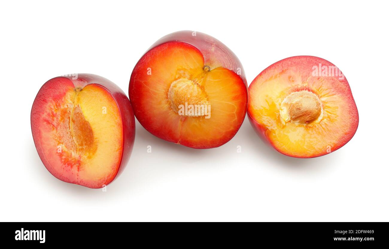 Cut plums isolated on white background Stock Photo - Alamy