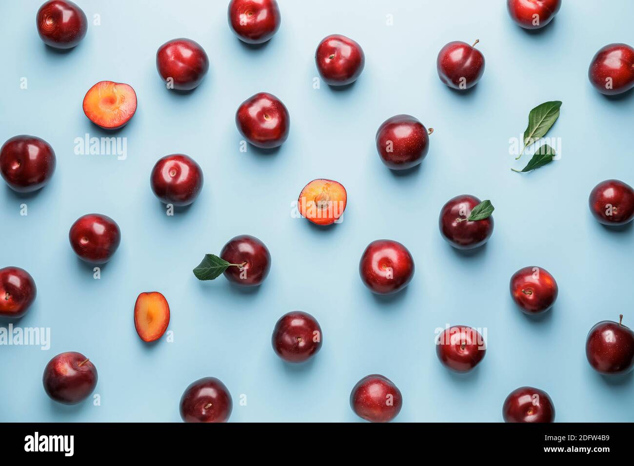 Fresh ripe plums on color background Stock Photo - Alamy