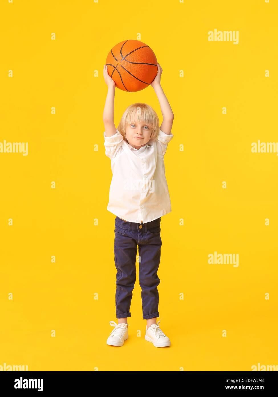 Cute sporty boy with basketball on color background Stock Photo - Alamy