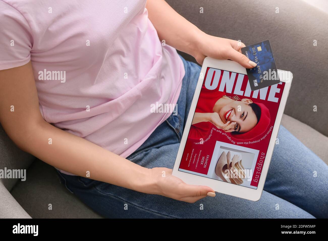 Young woman with tablet computer and credit card at home. Online ...