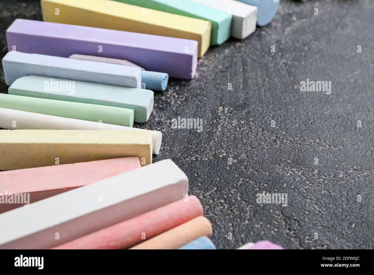 Colorful chalks on dark background Stock Photo - Alamy