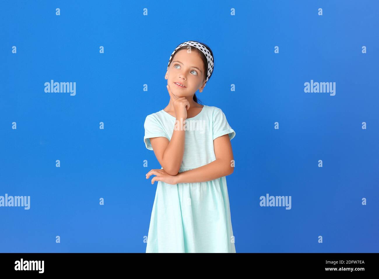 Cute little girl on color background Stock Photo - Alamy