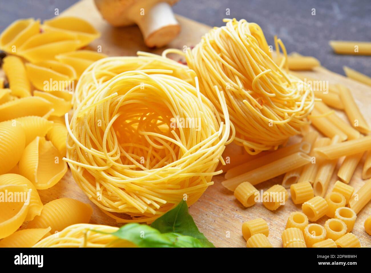 Different uncooked pasta on dark background Stock Photo - Alamy