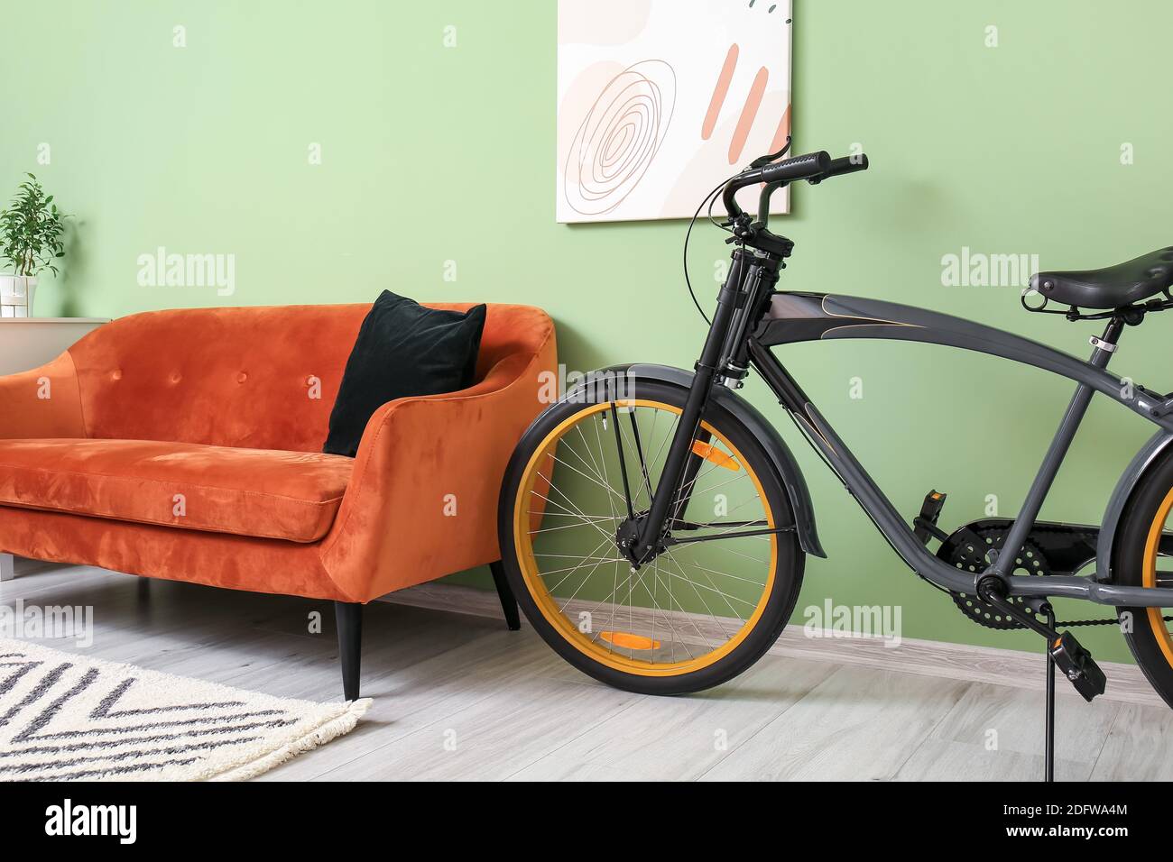 Interior of modern room with bicycle and sofa Stock Photo - Alamy