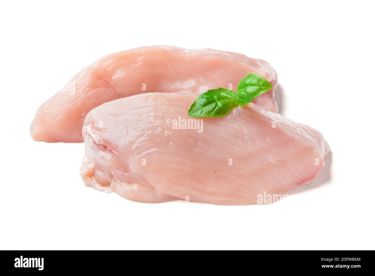 Raw cut chicken fillet with basil on white background Stock Photo - Alamy