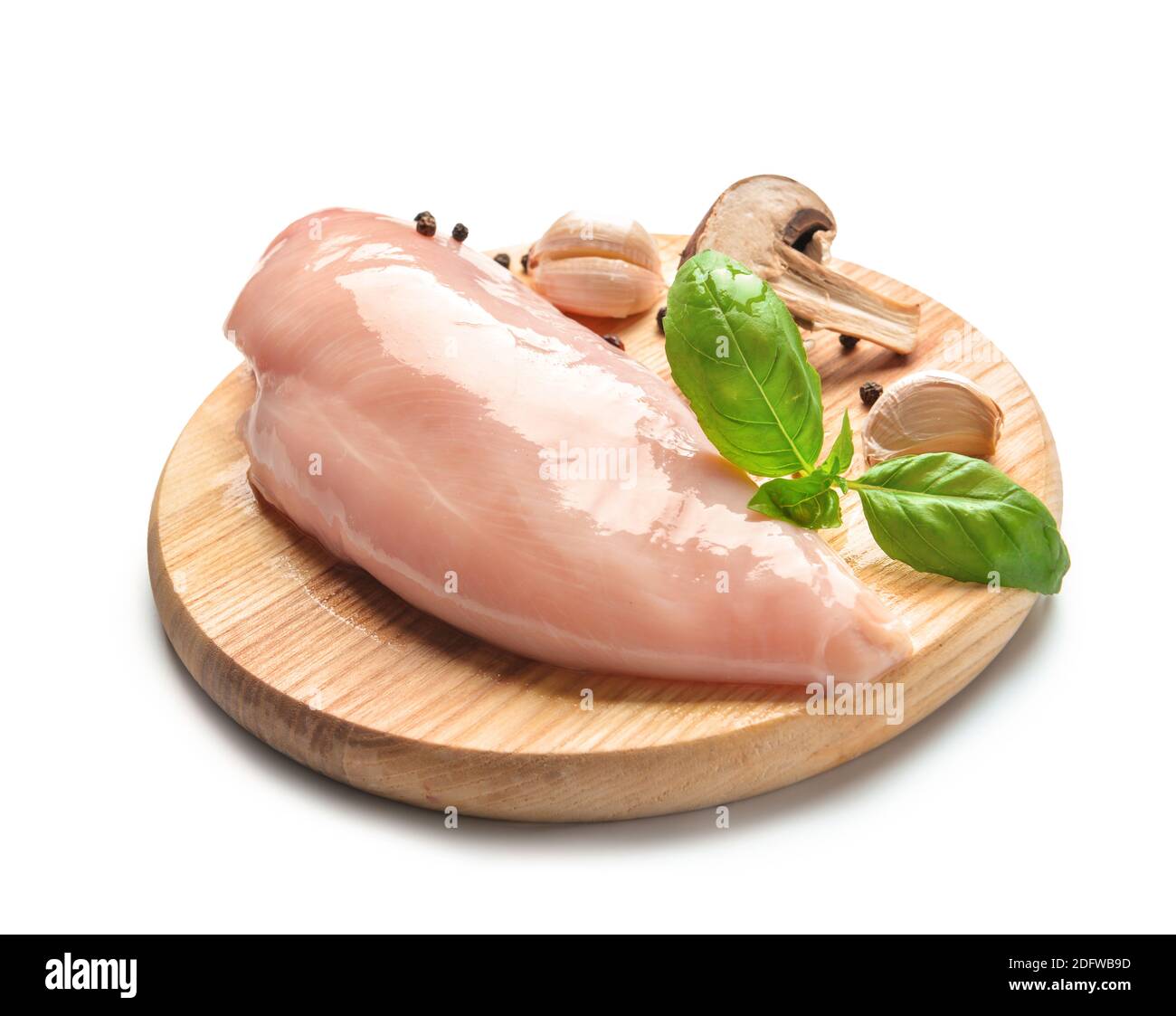 Board with raw chicken fillet on white background Stock Photo - Alamy