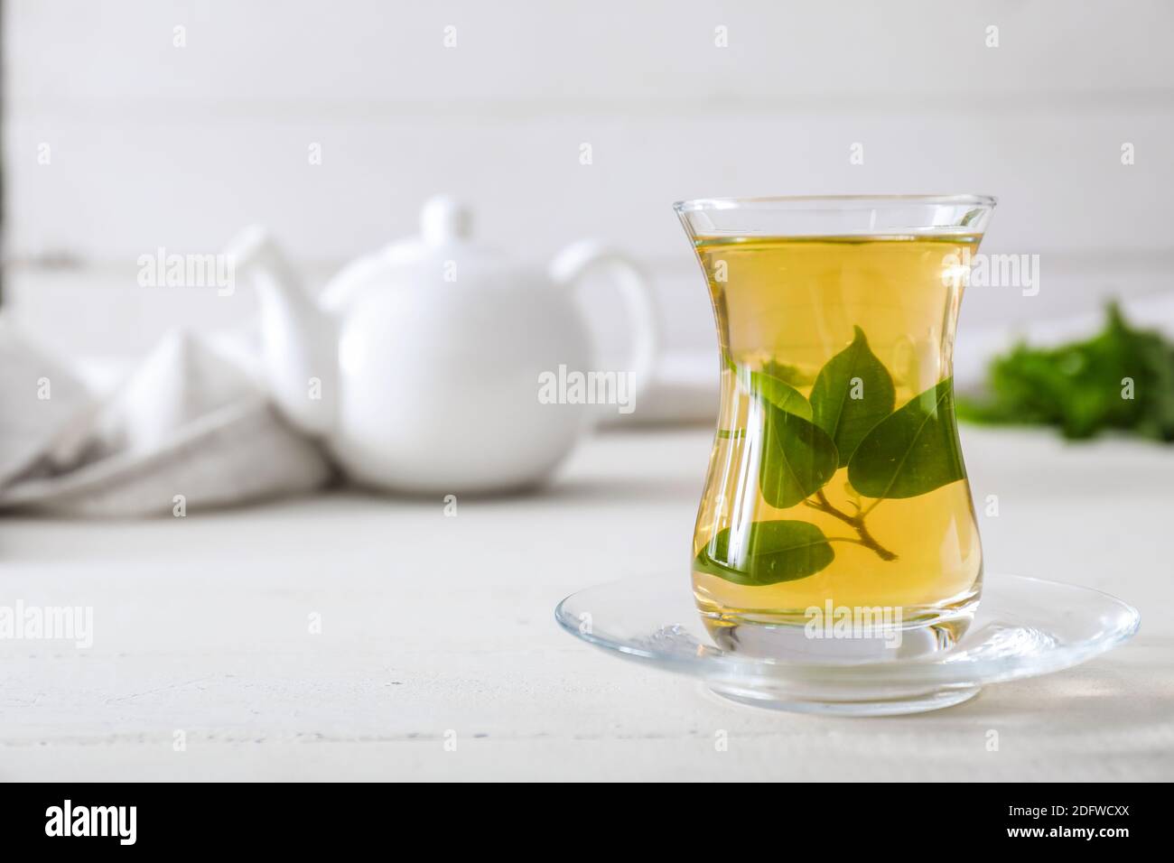 Cup of hot aromatic tea with green tea leaves on table Stock Photo - Alamy