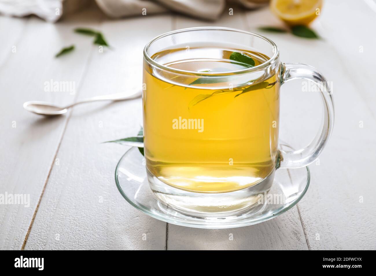 Cup of hot aromatic tea and green tea leaves on table Stock Photo - Alamy