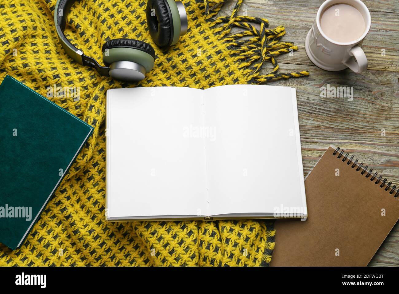 Books with plaid, headphones and cup of coffee on wooden background ...