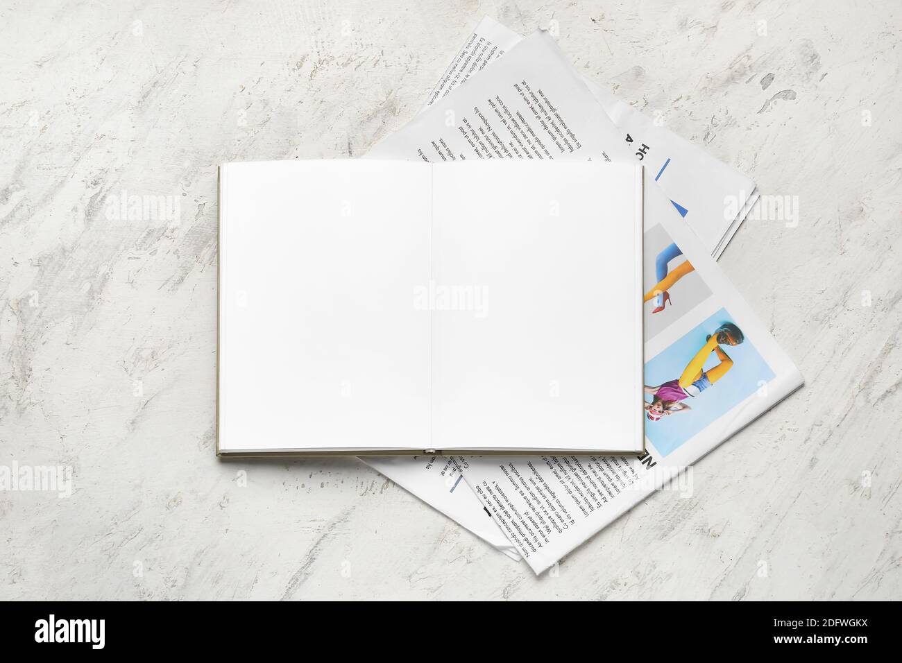 Blank book with newspapers on white background Stock Photo - Alamy