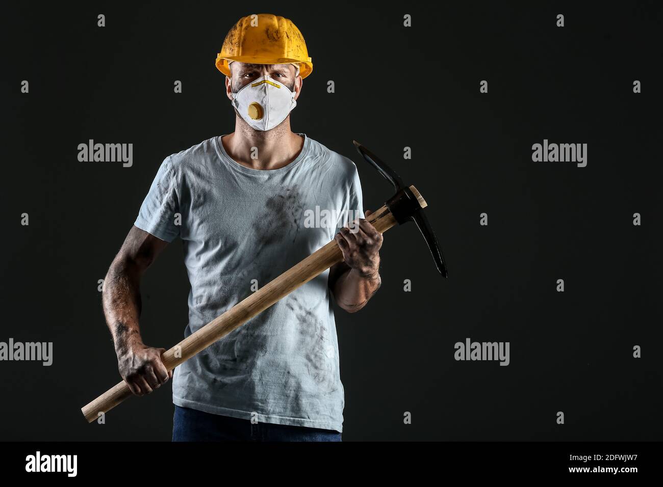 Miner man with pick axe on dark background Stock Photo - Alamy