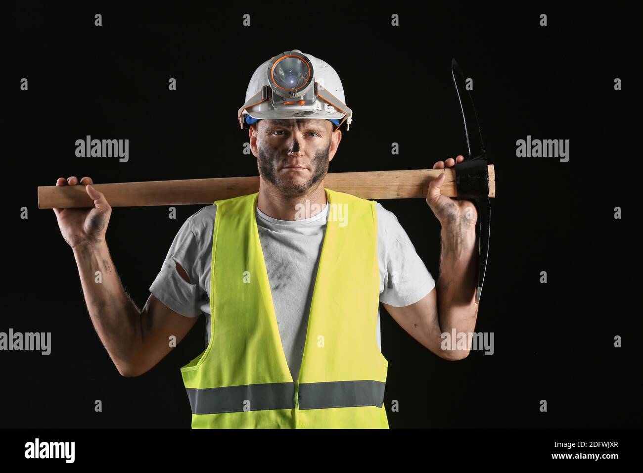 Miner man with pick axe on dark background Stock Photo - Alamy