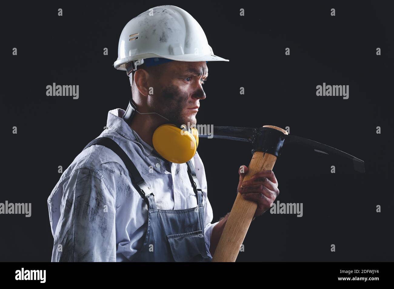 Miner man with pick axe on dark background Stock Photo - Alamy