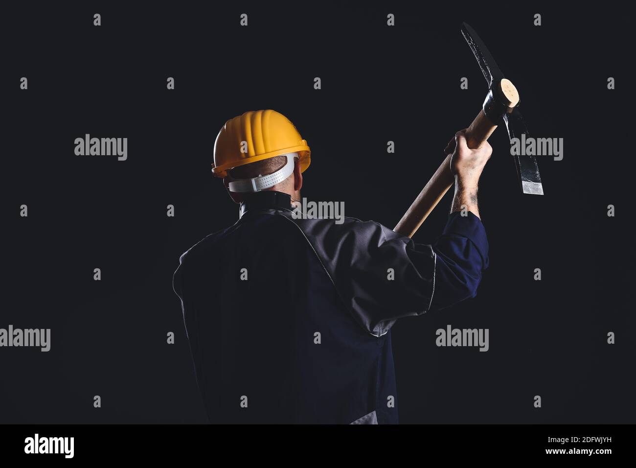 Miner man with pick axe on dark background Stock Photo - Alamy