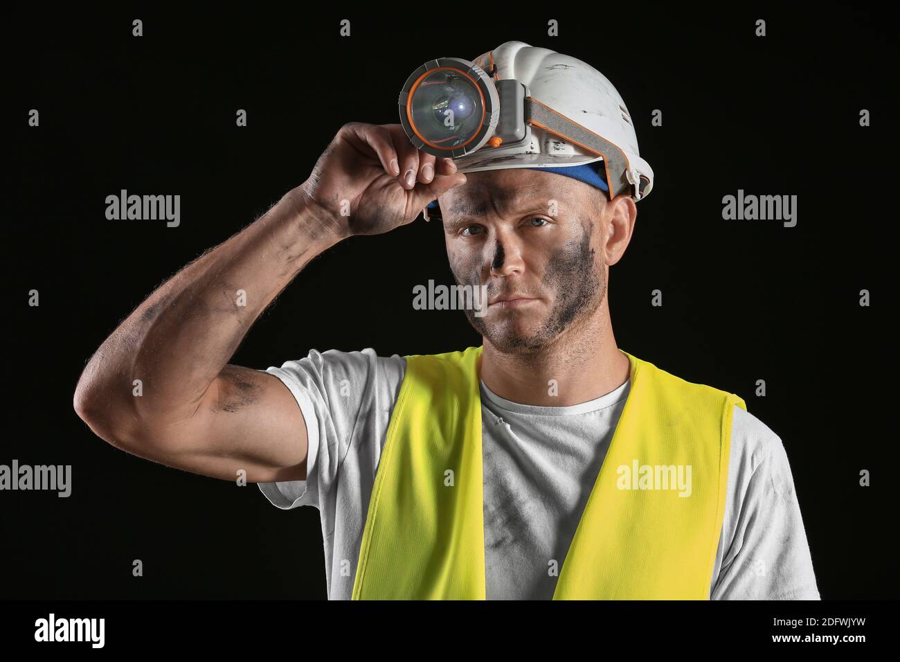 Miner man on dark background Stock Photo - Alamy