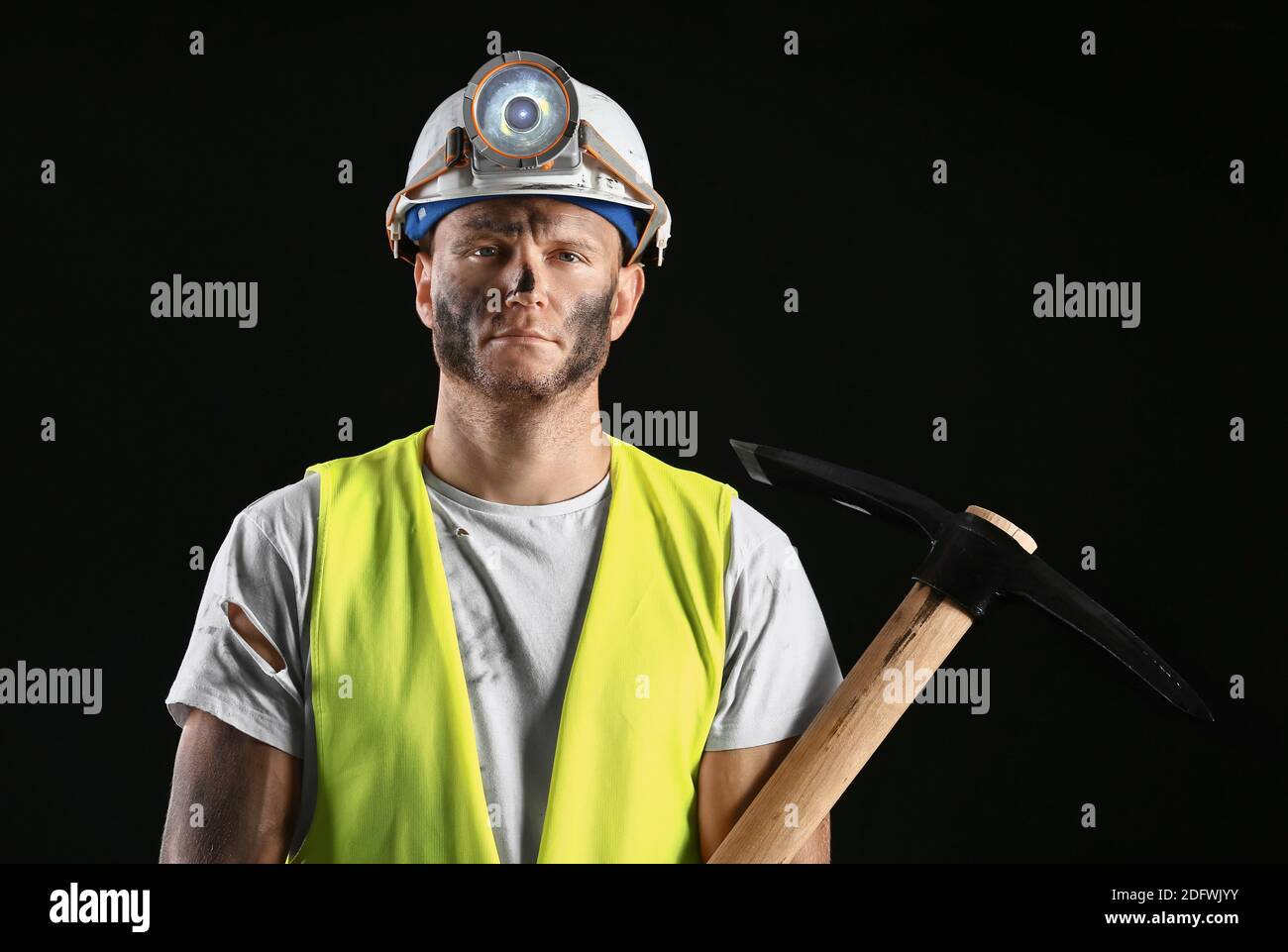 Miner man with pick axe on dark background Stock Photo - Alamy