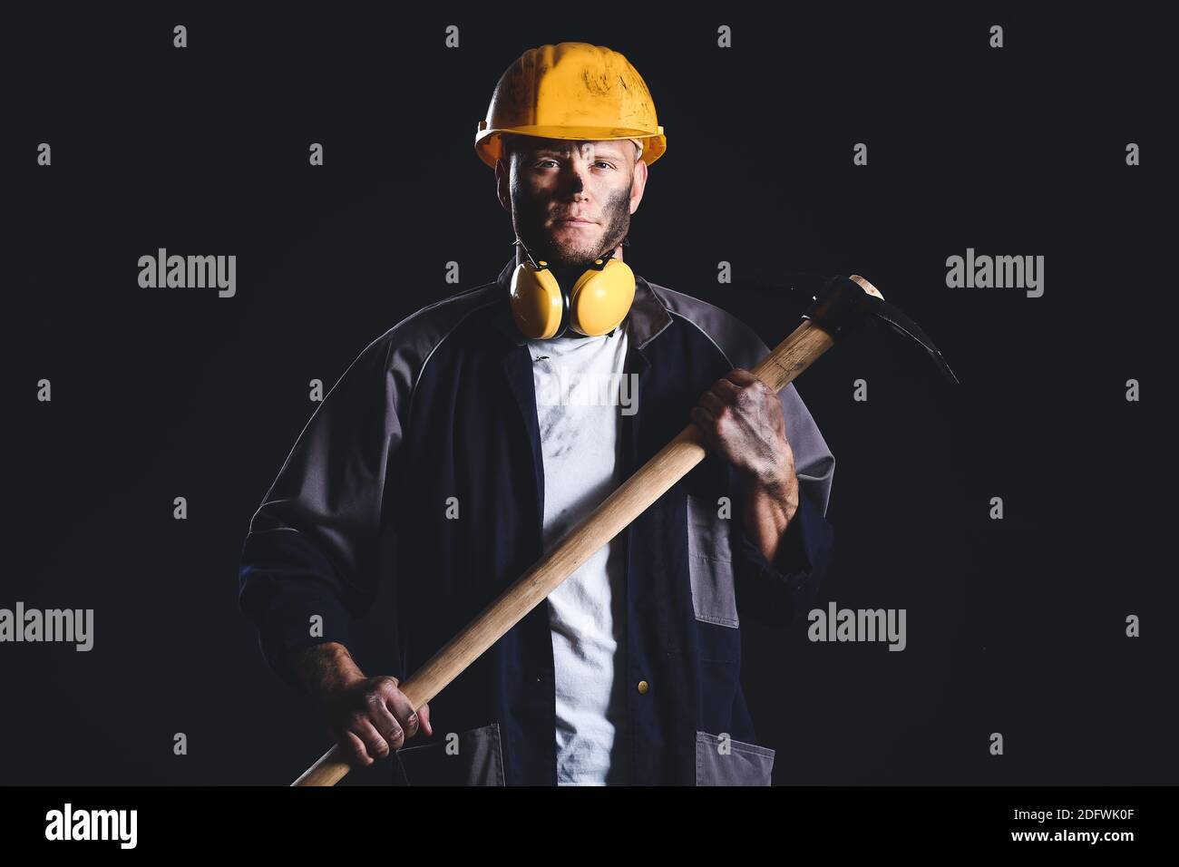 Miner man with pick axe on dark background Stock Photo - Alamy