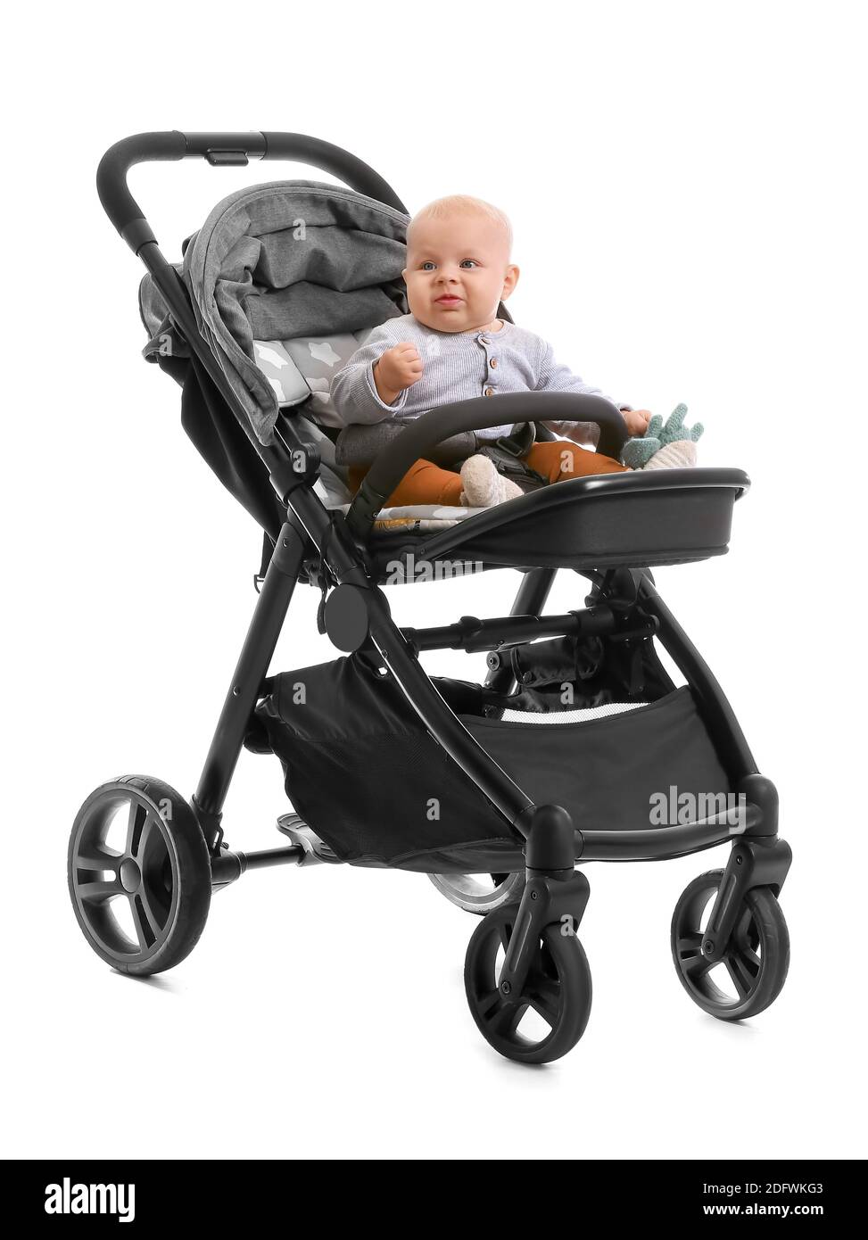 Cute funny baby in stroller on white background Stock Photo - Alamy