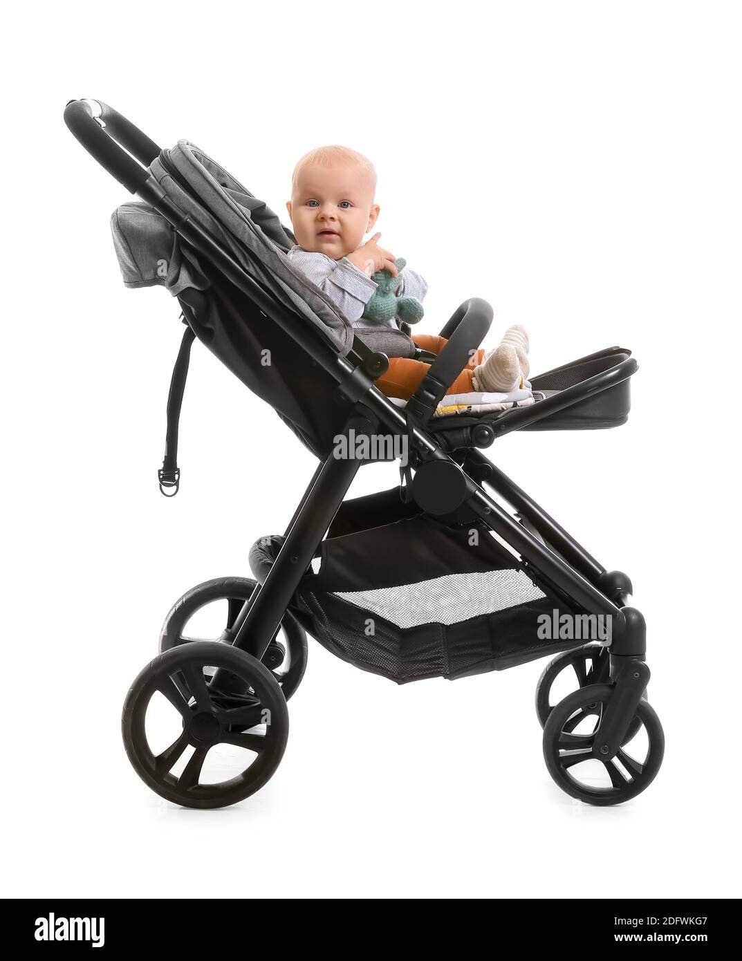Cute funny baby in stroller on white background Stock Photo - Alamy