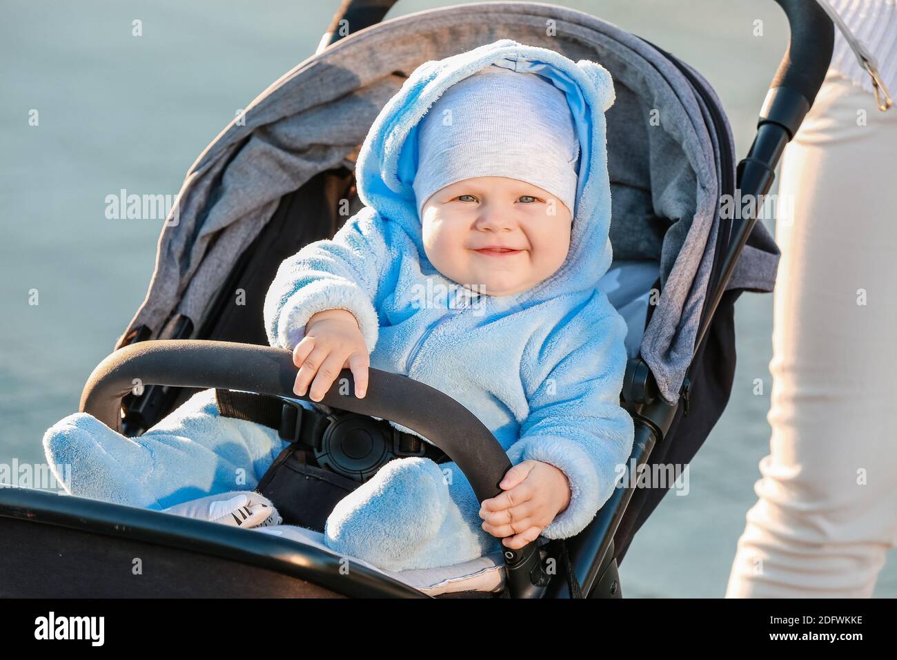 Cute funny baby in stroller outdoors Stock Photo - Alamy