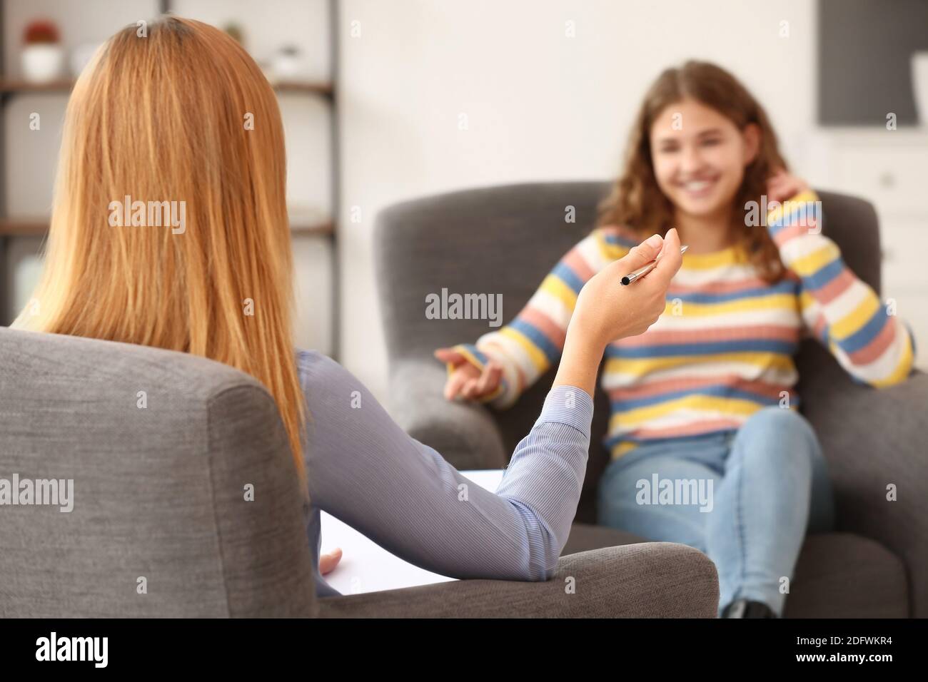 Psychologist working with teenage girl in office Stock Photo - Alamy