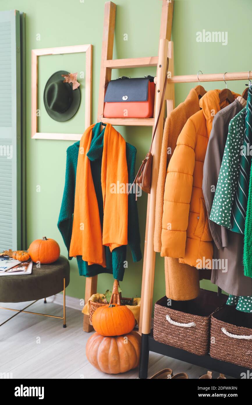 Rack with autumn clothes in interior of modern hallway Stock Photo - Alamy