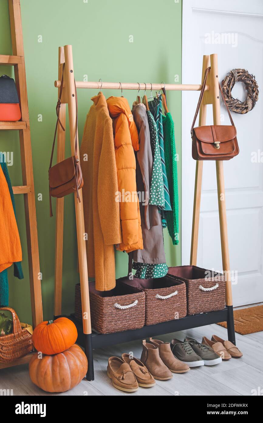 Rack with autumn clothes in interior of modern hallway Stock Photo - Alamy