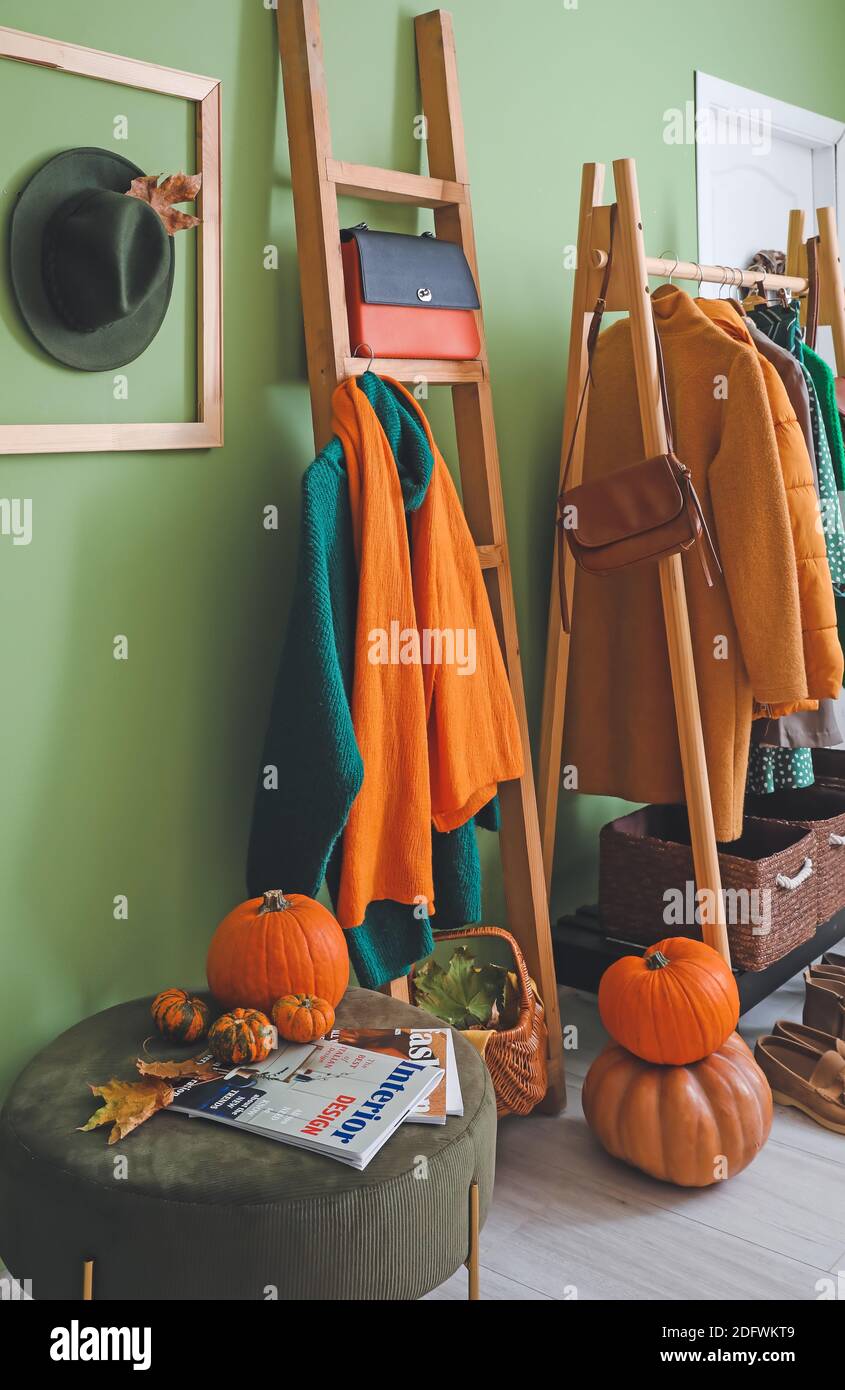 Rack with autumn clothes in interior of modern hallway Stock Photo - Alamy