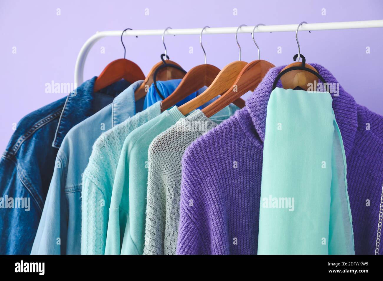Rack with modern clothes in room Stock Photo - Alamy