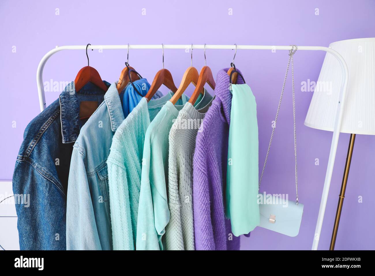 Rack with autumn clothes in interior of modern room Stock Photo - Alamy