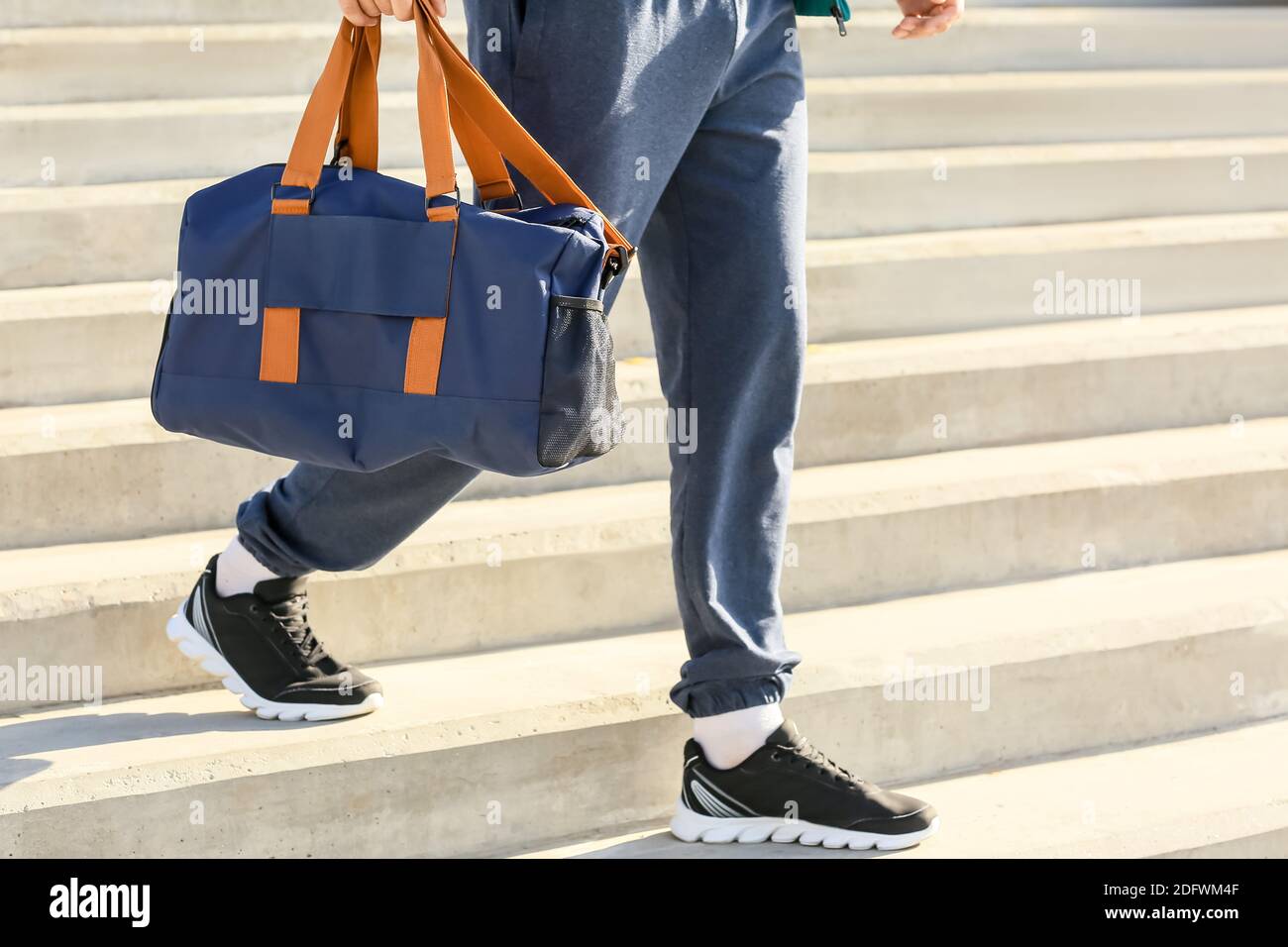 Sporty young man with bag outdoors Stock Photo - Alamy