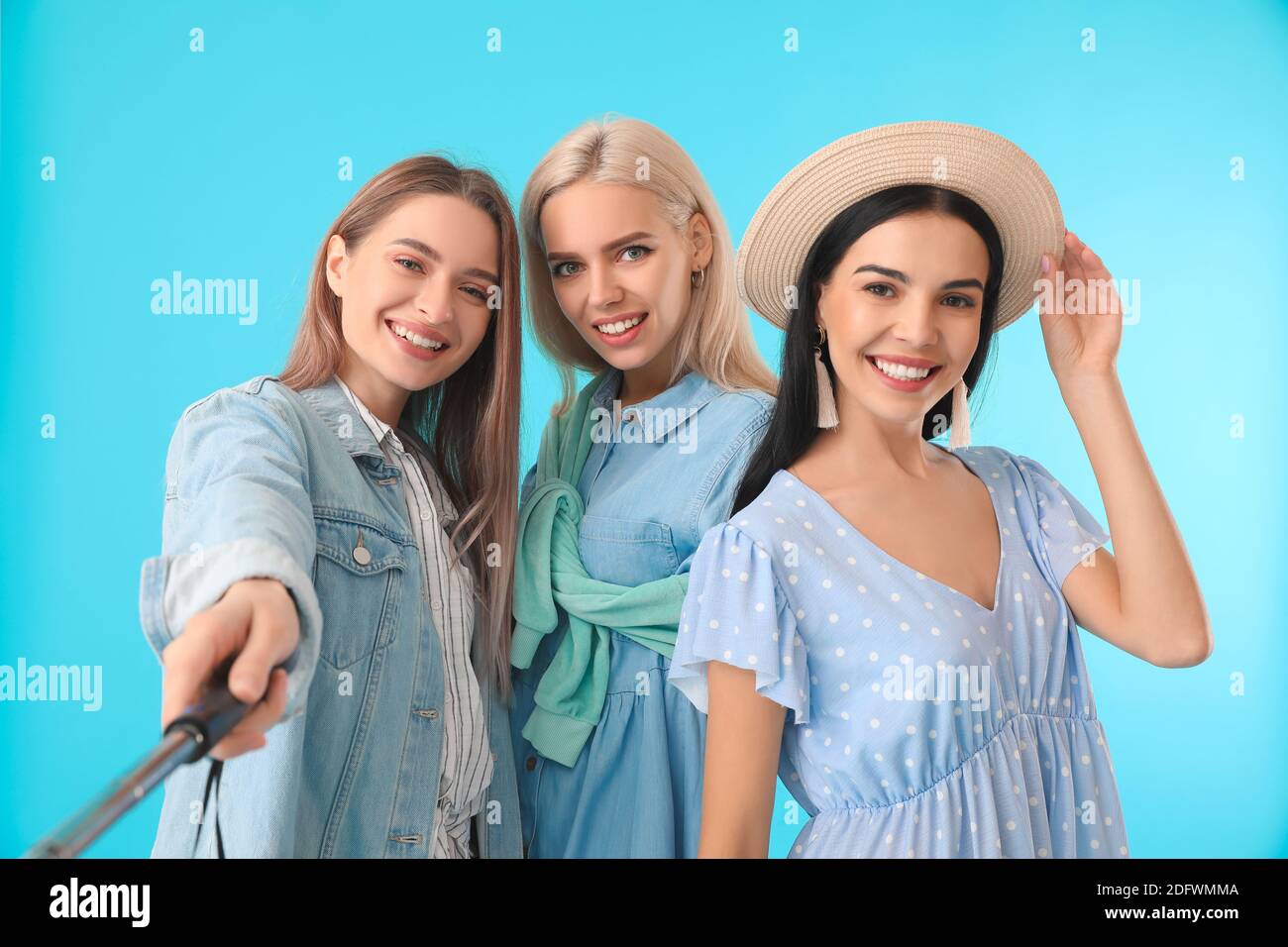 Beautiful young women taking selfie on color background Stock Photo - Alamy