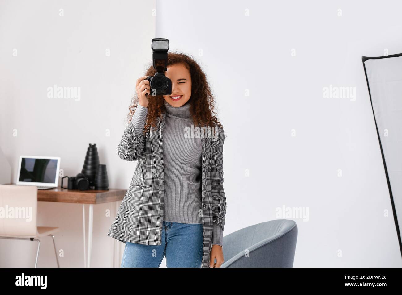 Female African-American photographer in studio Stock Photo - Alamy