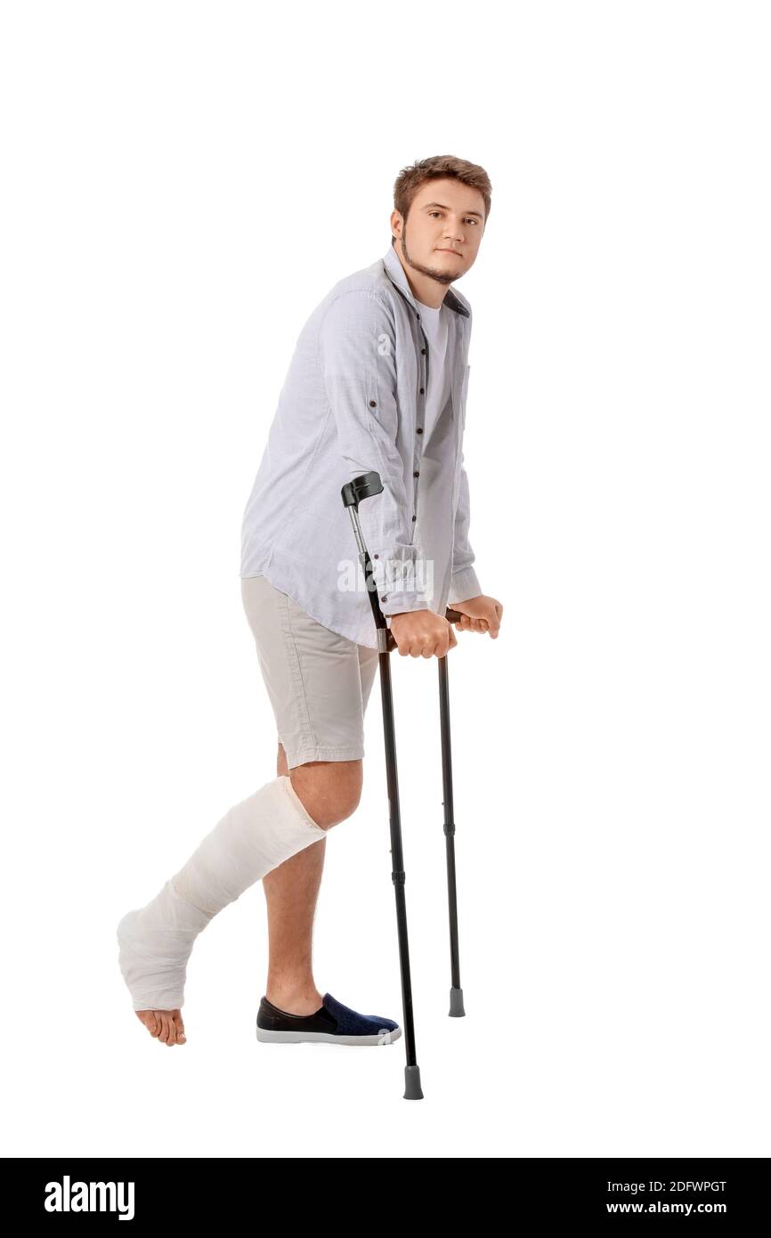 Young man with broken leg on white background Stock Photo - Alamy