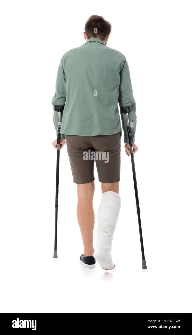 Young man with broken leg on white background Stock Photo - Alamy