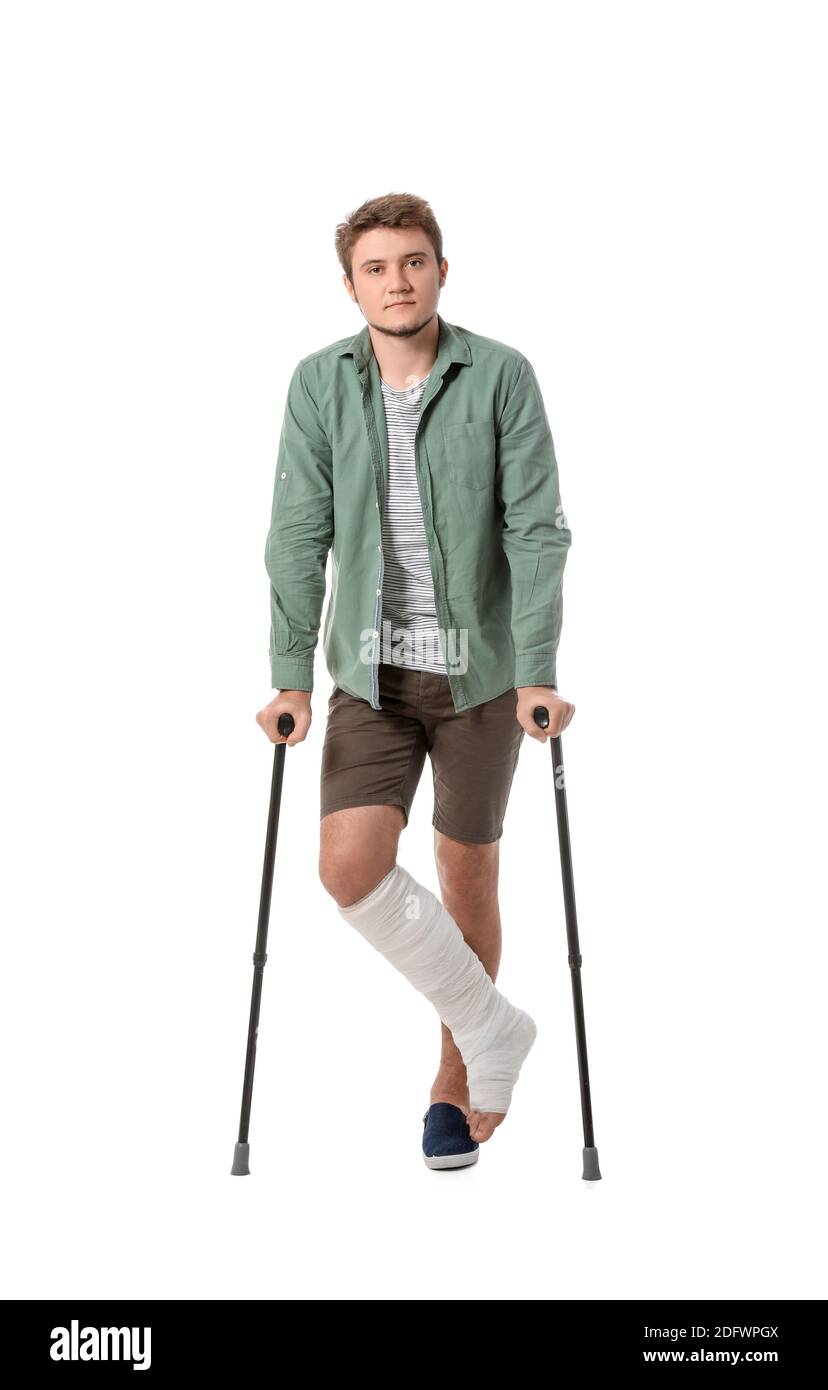 Young man with broken leg on white background Stock Photo - Alamy