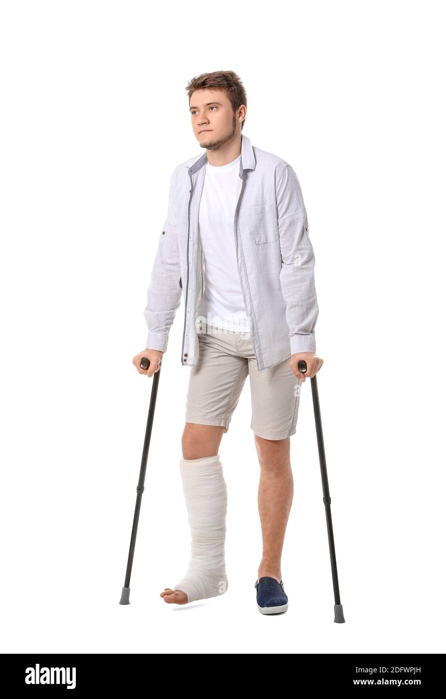 Young man with broken leg on white background Stock Photo - Alamy