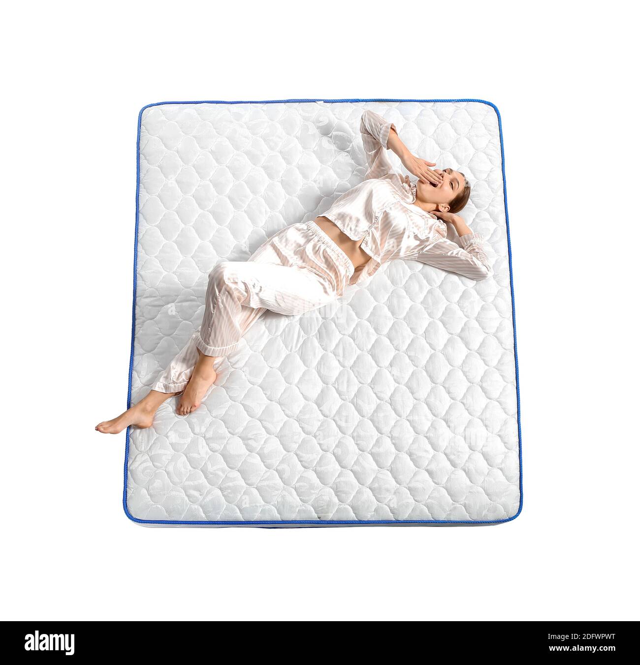 Woman lying on bed stretching Cut Out Stock Images & Pictures - Alamy