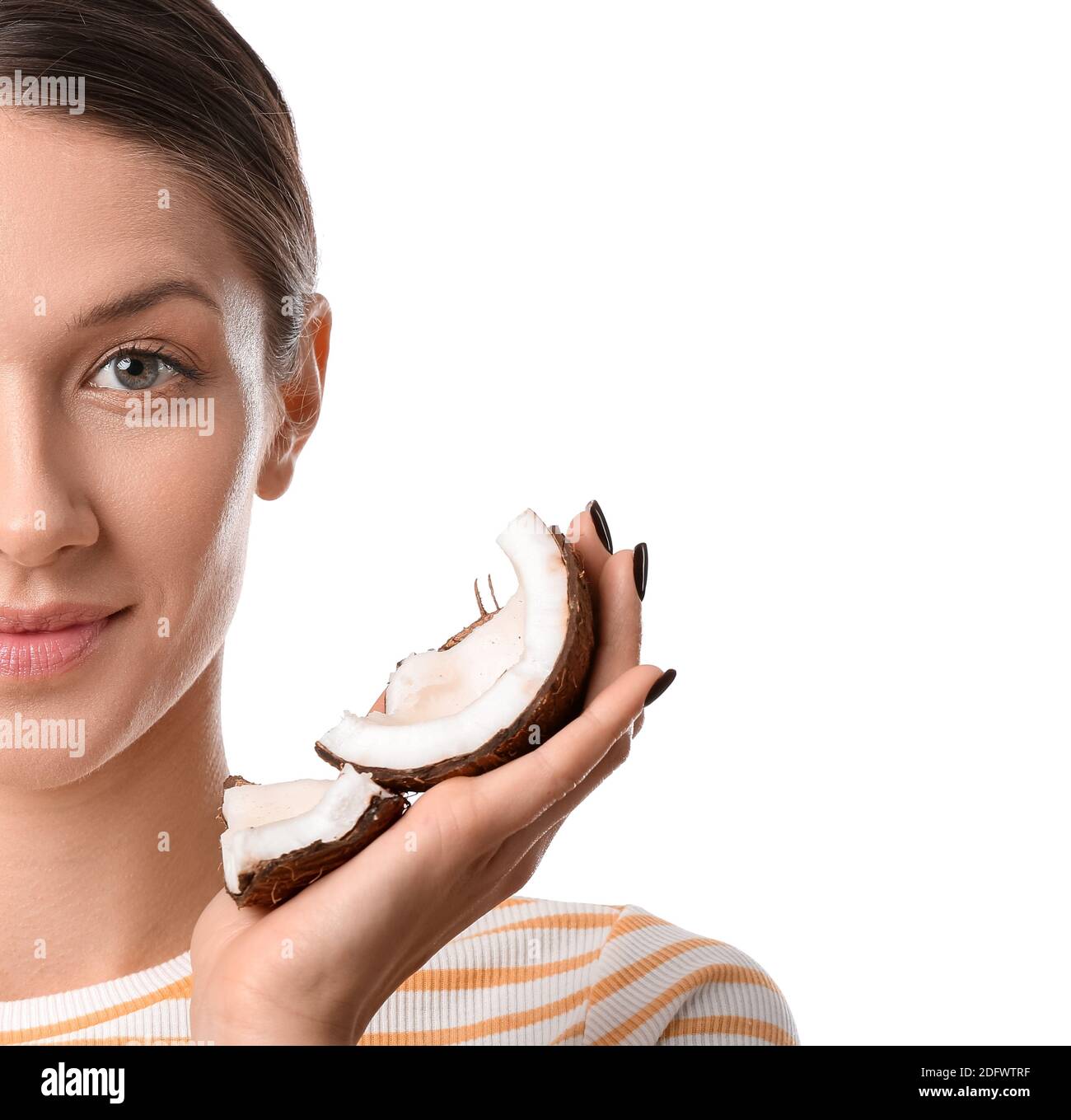 Beautiful young woman with coconut on white background Stock Photo - Alamy