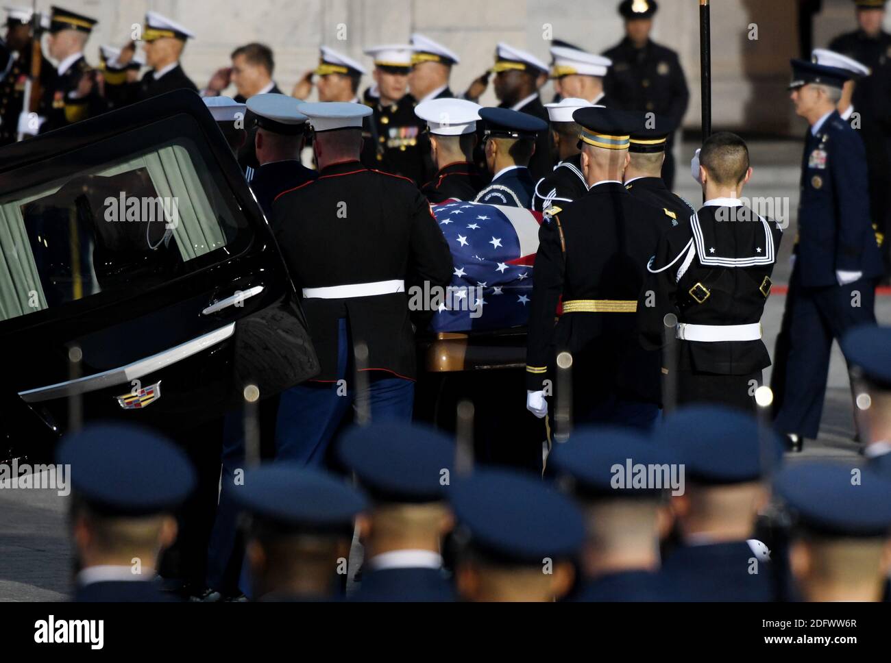 The casket carrying former President George H.W Bush is carried into ...