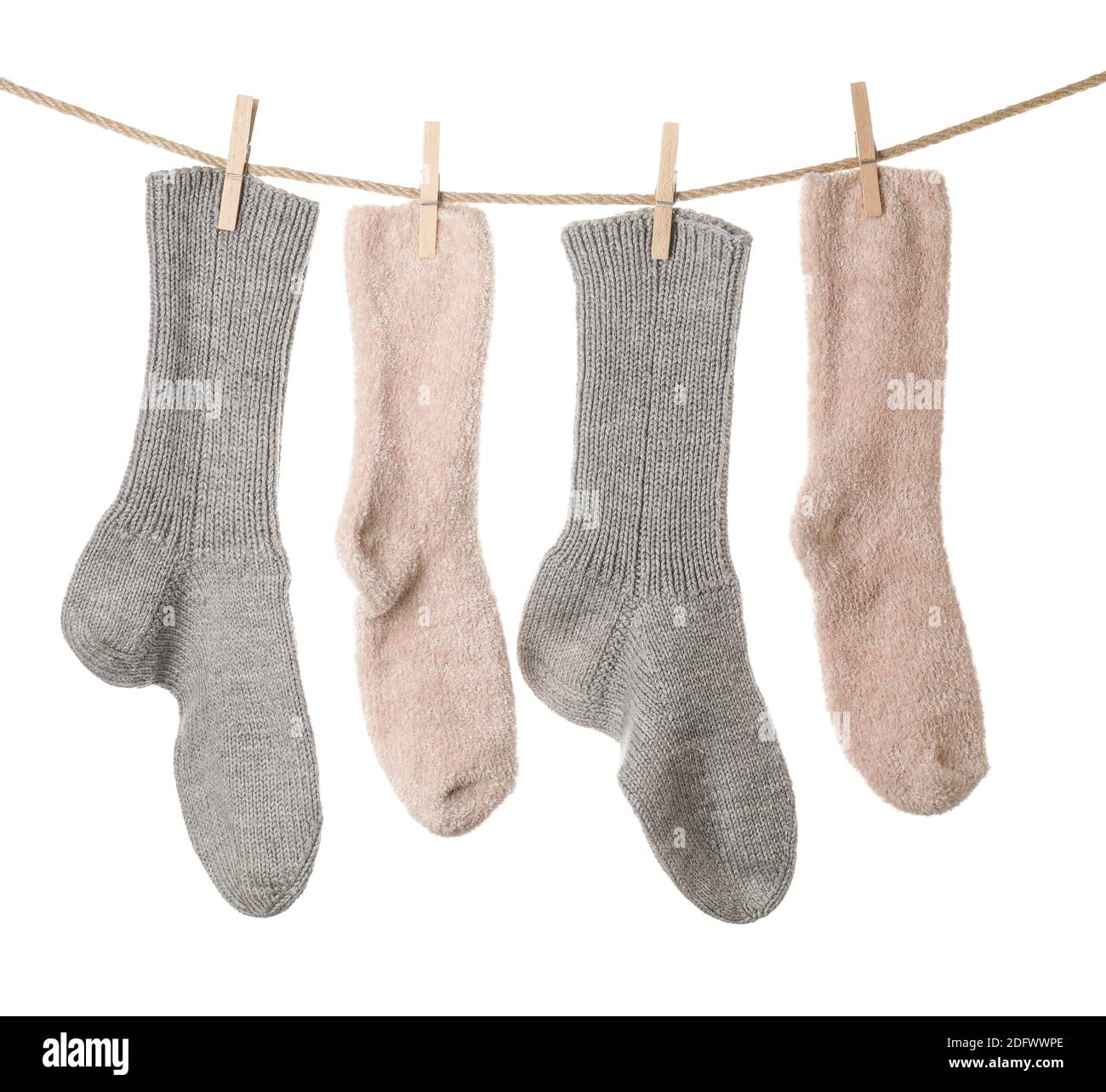 Warm socks hanging on clothes line against white background Stock Photo ...