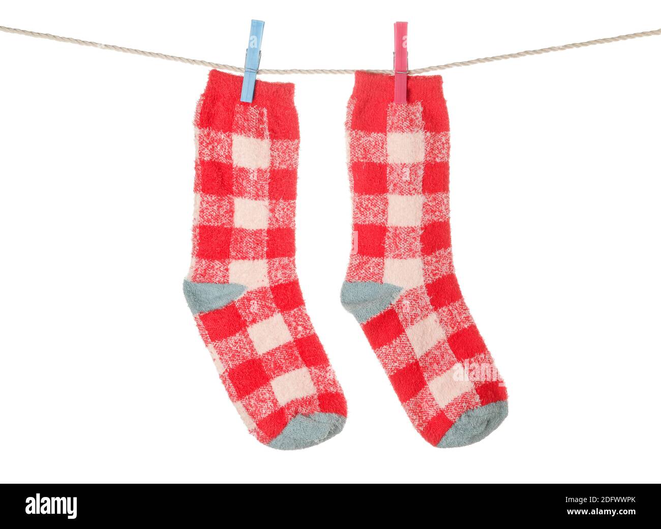 Warm socks hanging on clothes line against white background Stock Photo ...