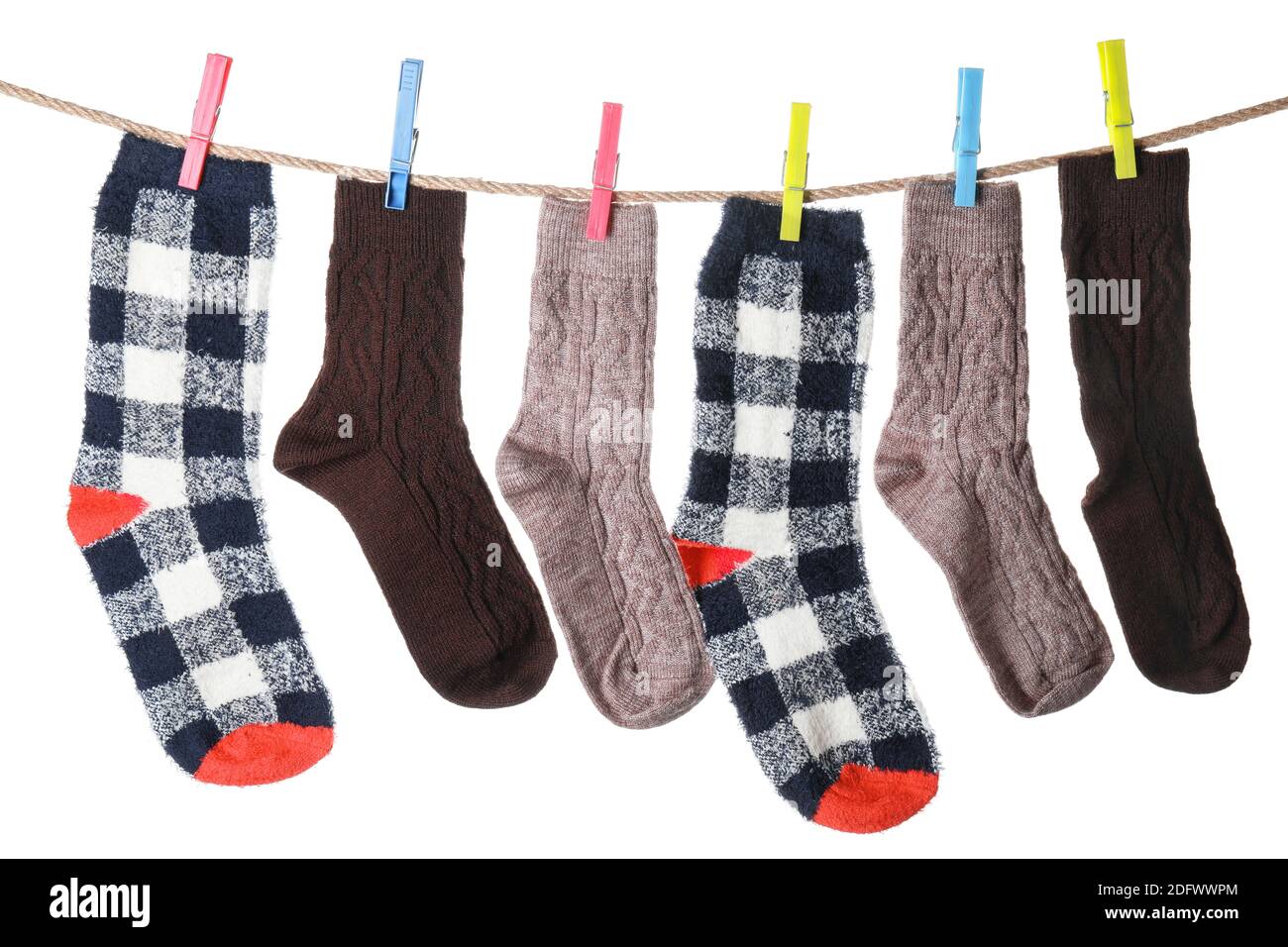 Warm socks hanging on clothes line against white background Stock Photo ...