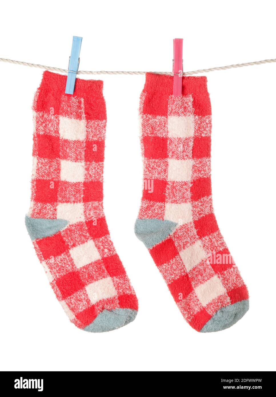 Warm socks hanging on clothes line against white background Stock Photo ...