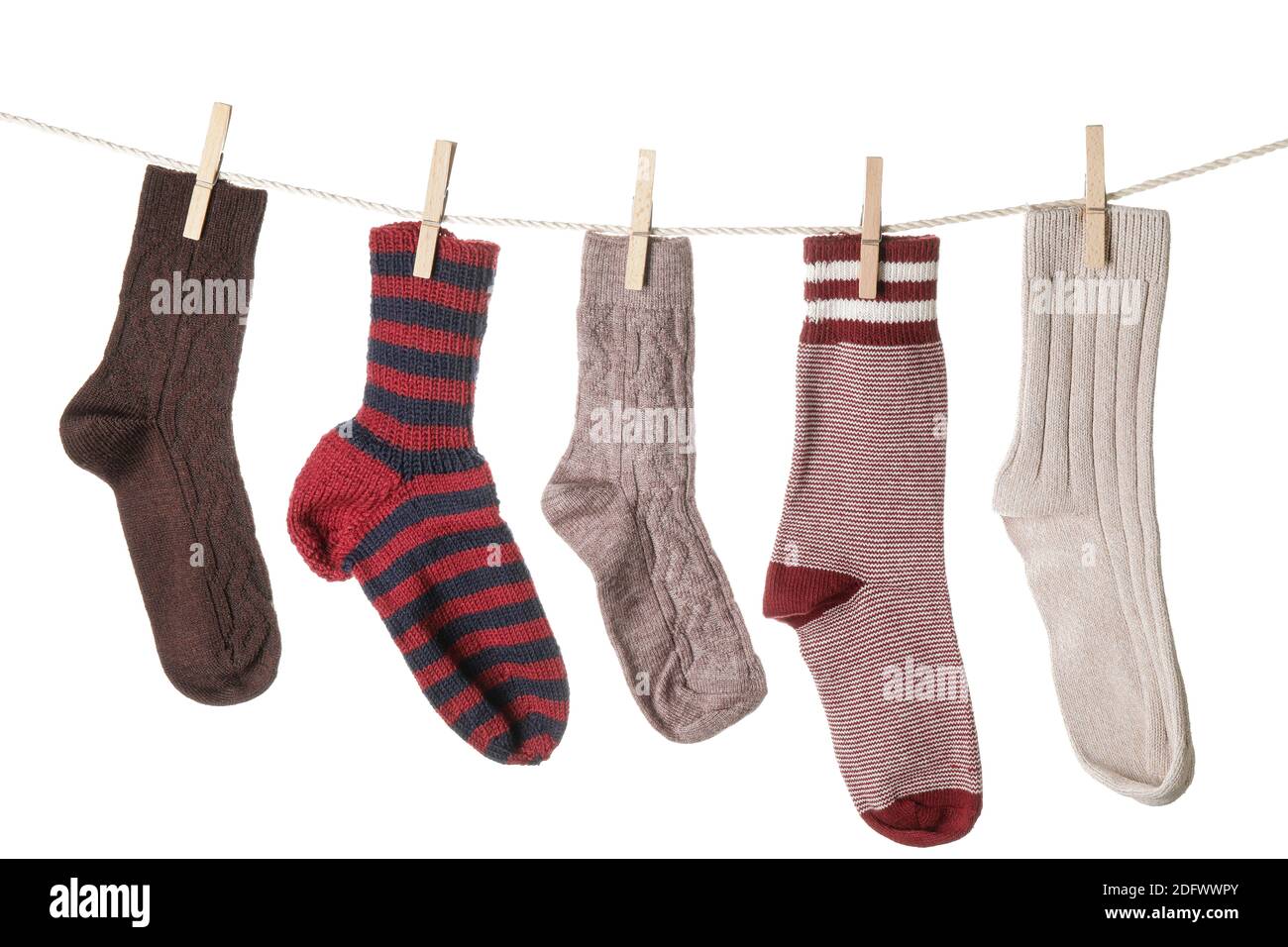 Warm socks hanging on clothes line against white background Stock Photo ...