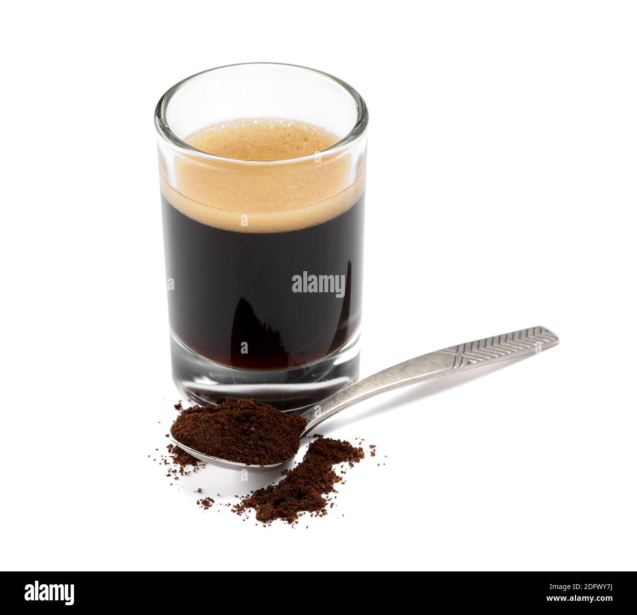 Glass of hot espresso and spoon with coffee powder on white background ...